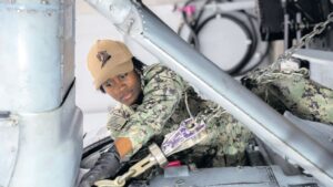 Sailor from Jamaica performs helicopter maintenance on flight deck of ...