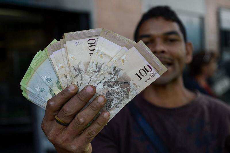 Venezuela devalues currency in crisis dollar sale - Jamaica Observer