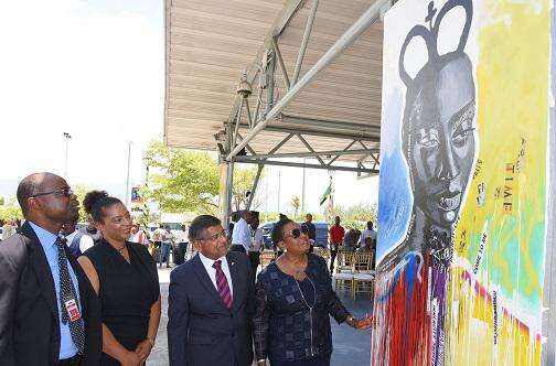 Grange unveils Windrush murals at Norman Manley Int'l Airport - Jamaica ...