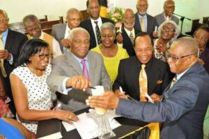 Celebrating by candle light - Jamaica Observer