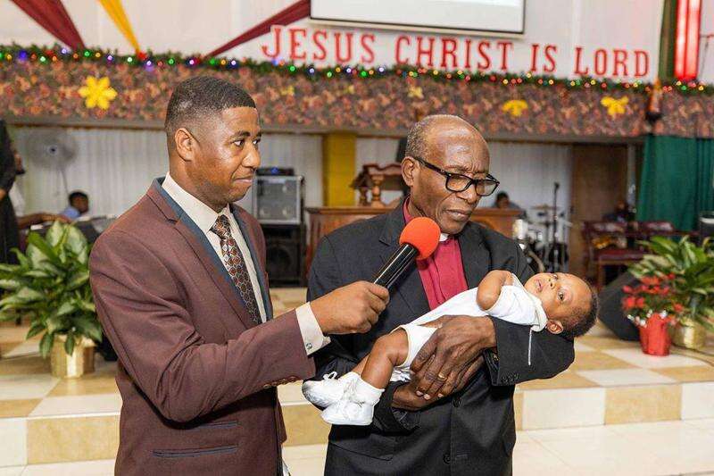 Asafa shares cute pictures of son’s christening - Jamaica Observer