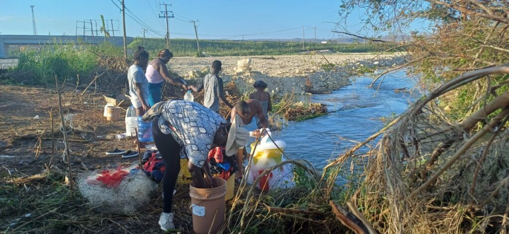 Trelawny residents join long queues to fetch river water after ...